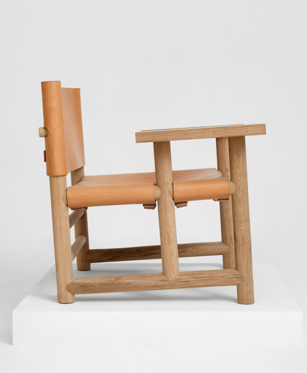 Unique to the sofa are its seat cushions, which are strung over a ...