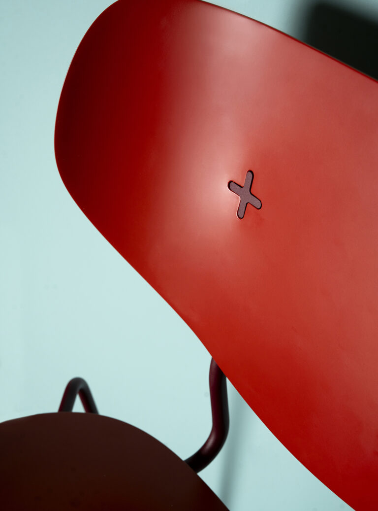 The plus sign on the backrest is the symbol that identifies the chair ...